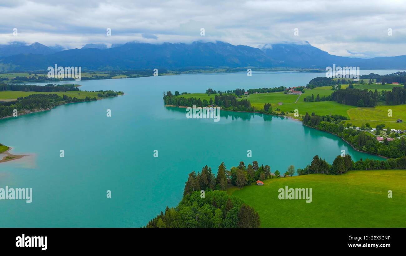 Aerial view over Lake Forggensee at the city of Fuessen in Germany ...