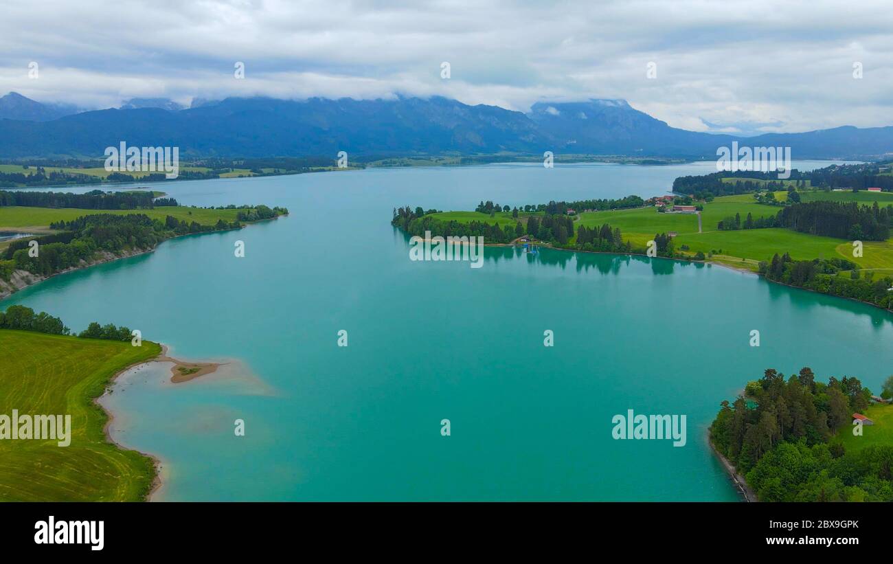 Aerial view over Lake Forggensee at the city of Fuessen in Germany ...