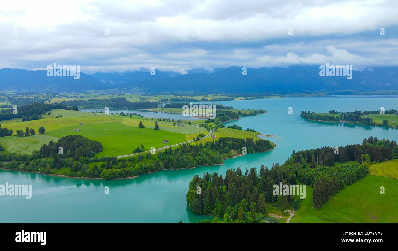 Aerial view over Lake Forggensee at the city of Fuessen in Germany ...