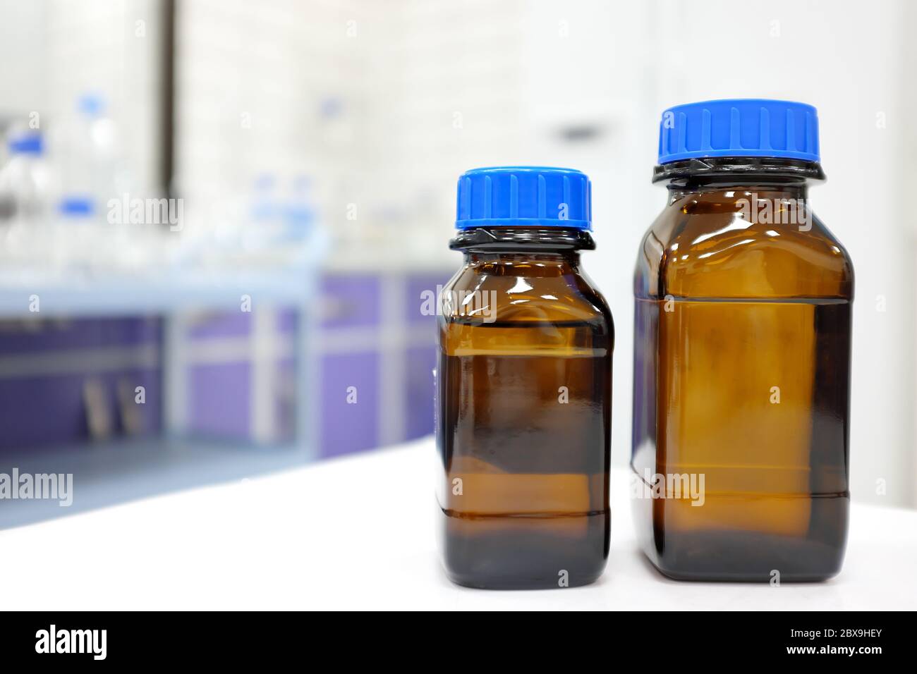 No label amber glass bottle with clear liquid chemical inside a ...