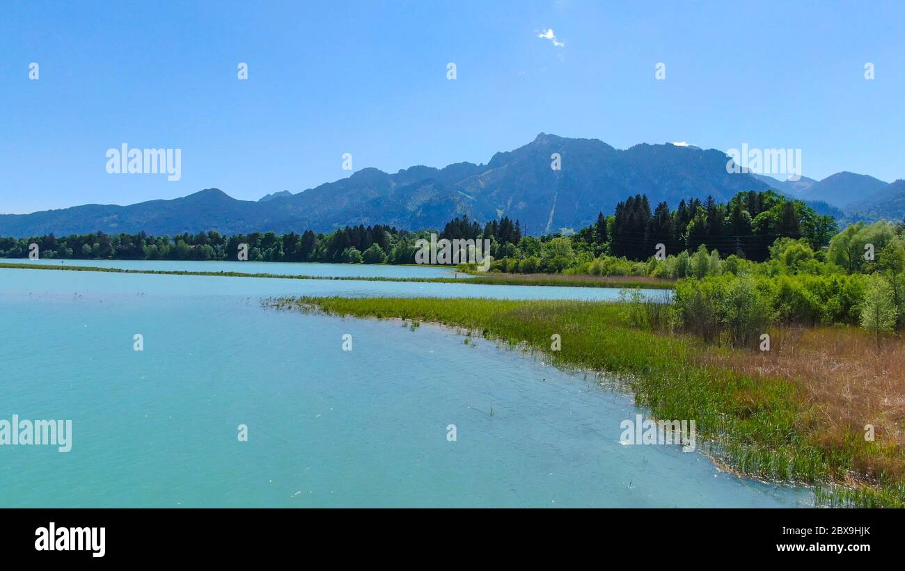 Aerial view over Lake Forggensee at the city of Fuessen in Germany ...