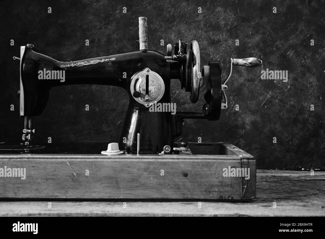 Old, retro, vintage sewing machine on a dark background of an abstract ...