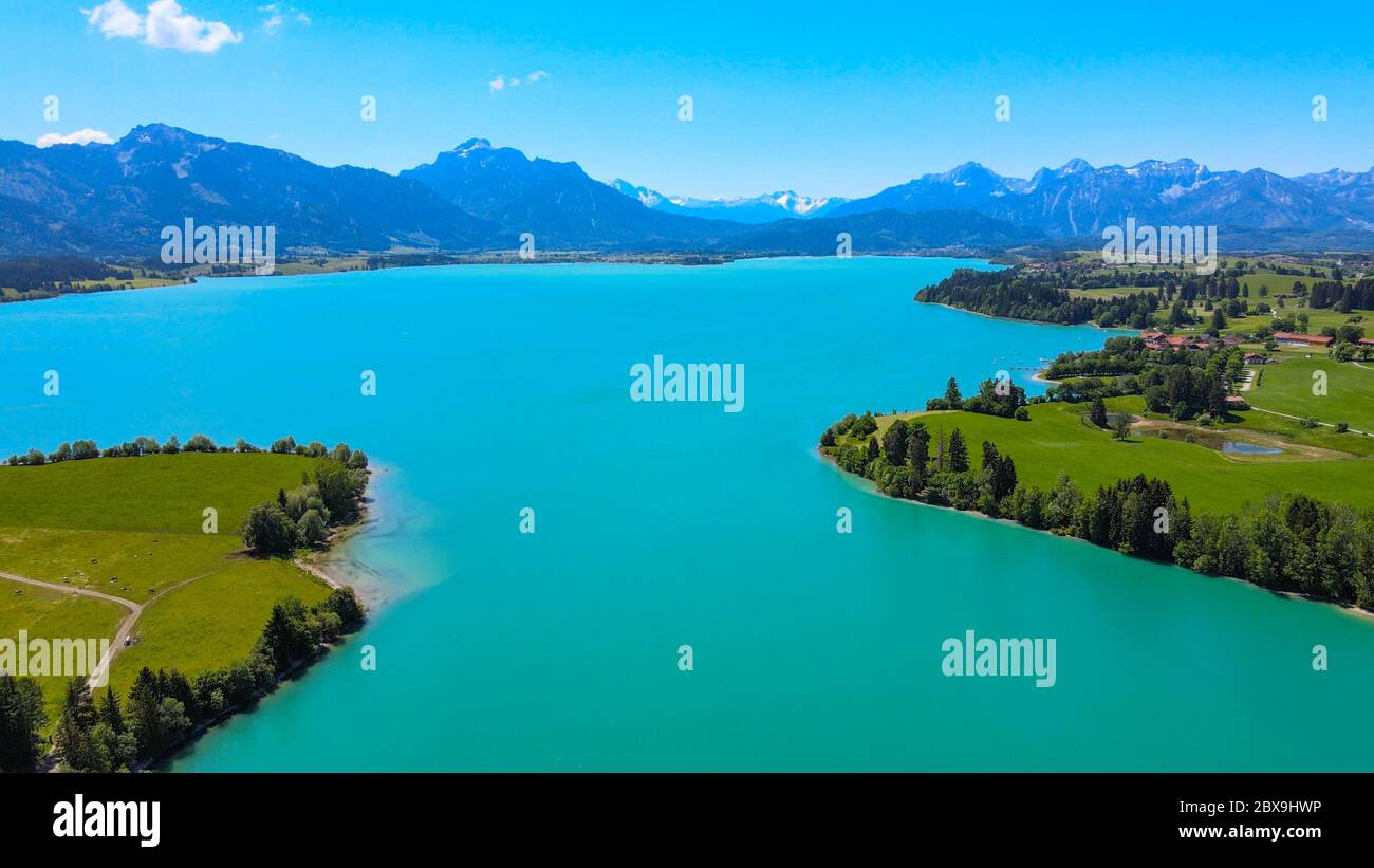 Aerial view over Lake Forggensee at the city of Fuessen in Germany ...