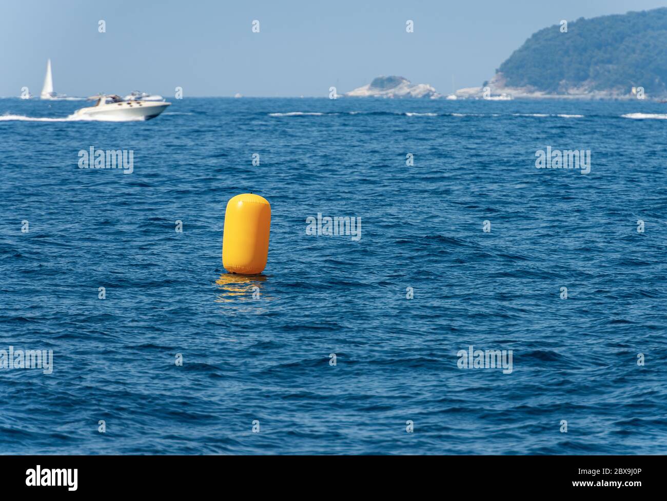 One large yellow inflatable signal buoy floating in the Mediterranean ...