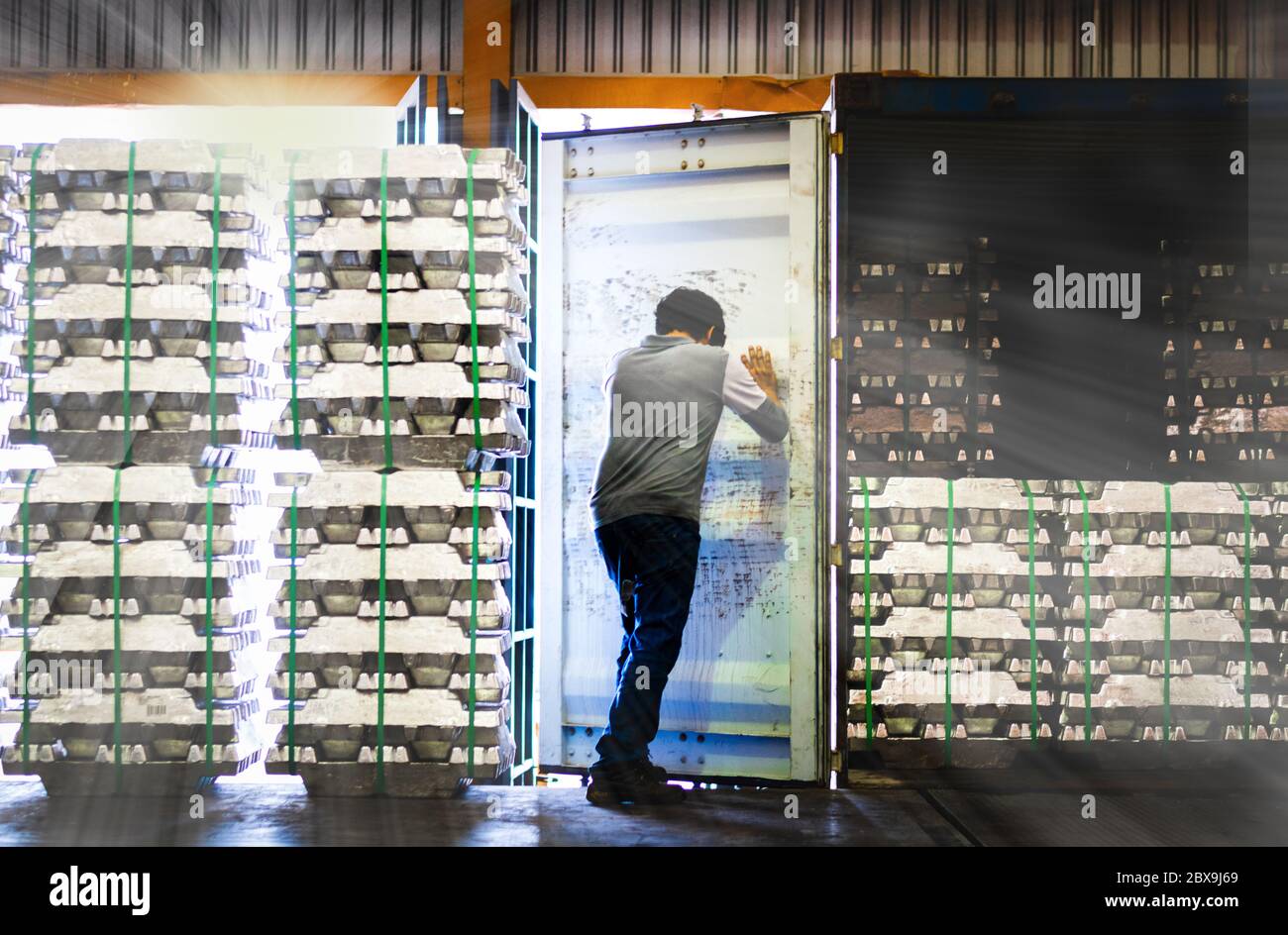 Open container cargo and unstuffing aluminum ingot on warehouse dock ...