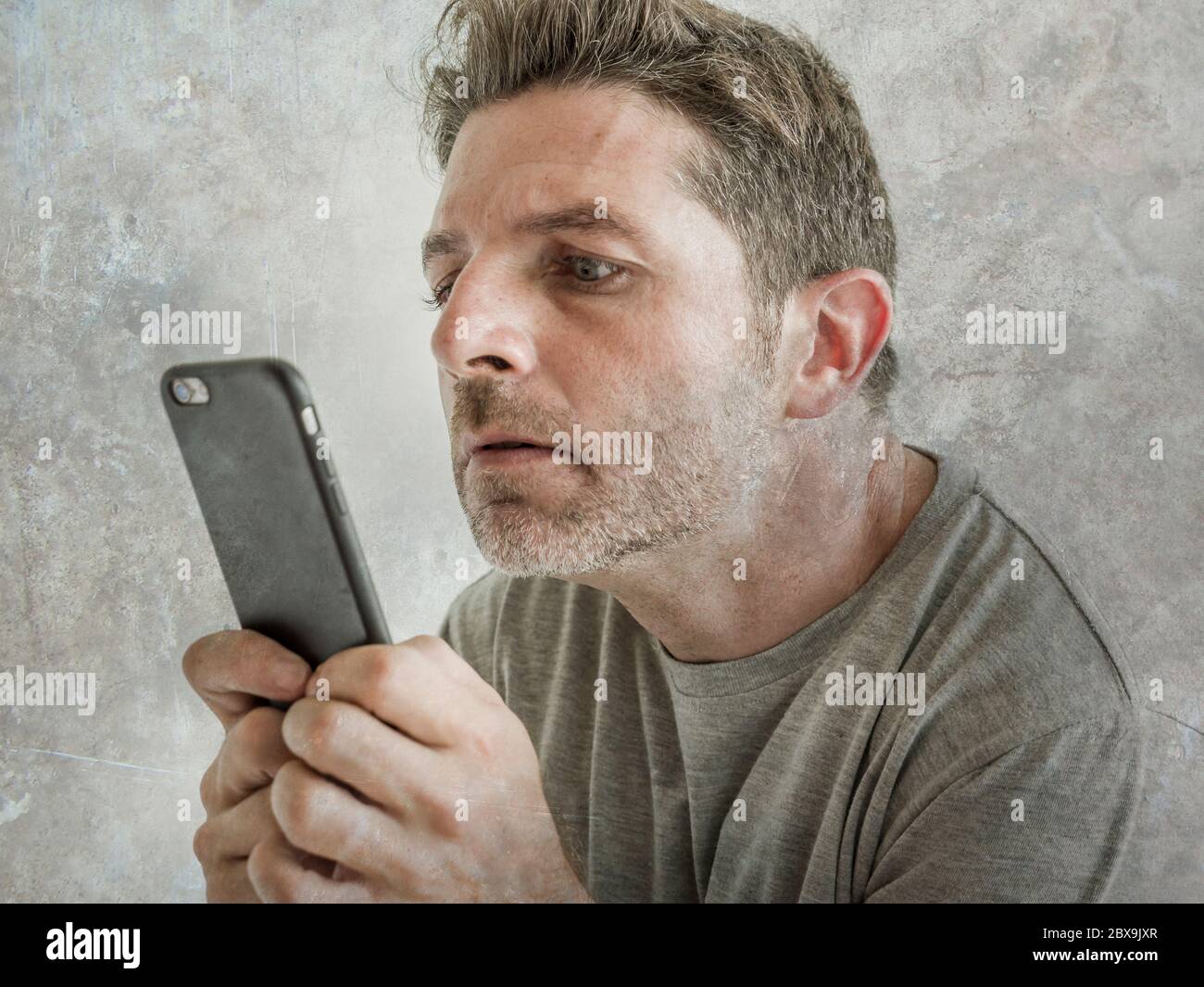 freak and weird looking man using mobile phone watching something ...