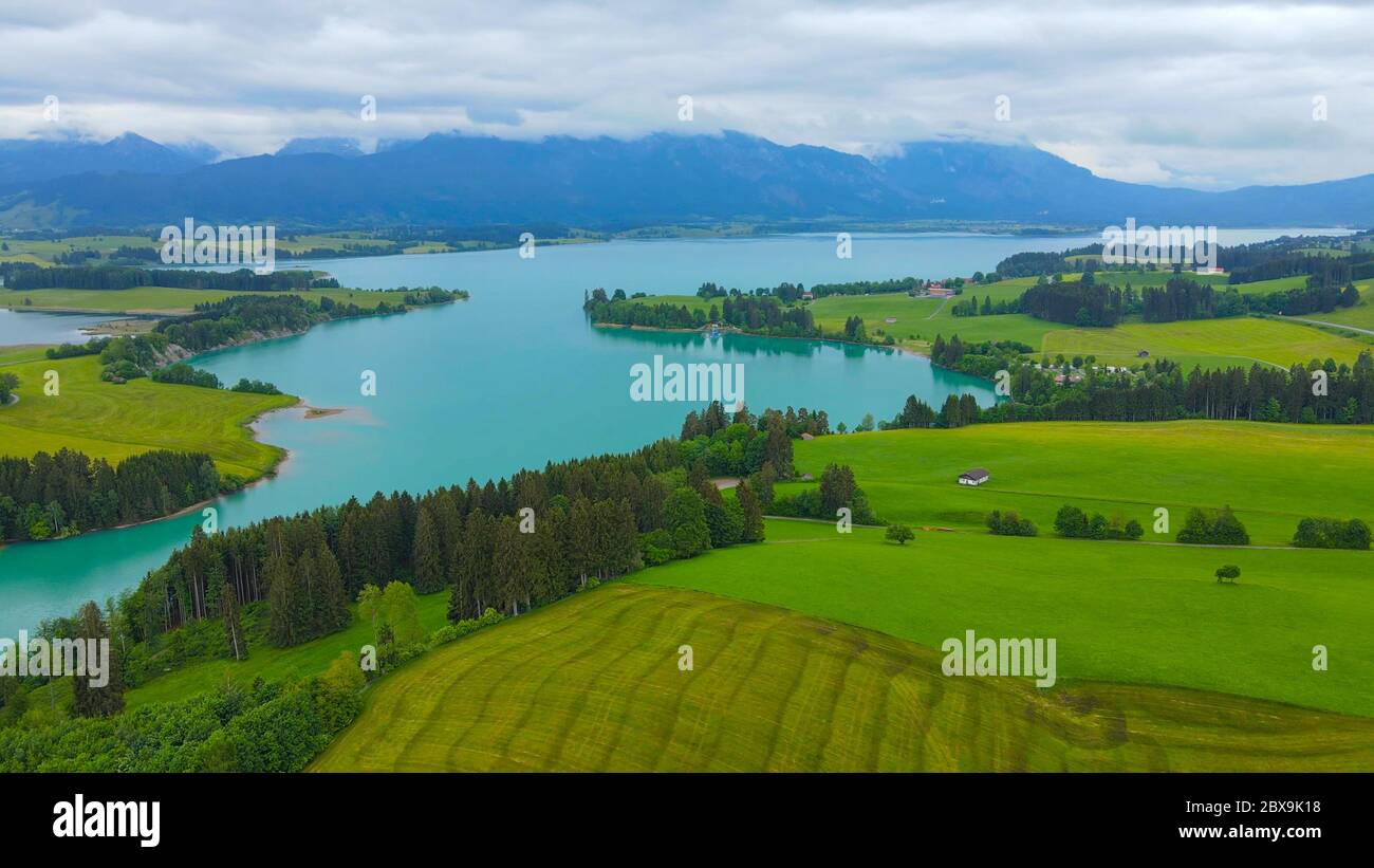 Aerial view over Lake Forggensee at the city of Fuessen in Germany ...