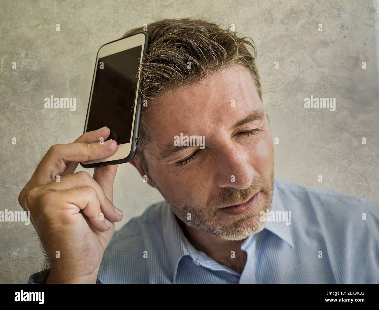 grunge portrait of frustrated and depressed business man holding mobile ...