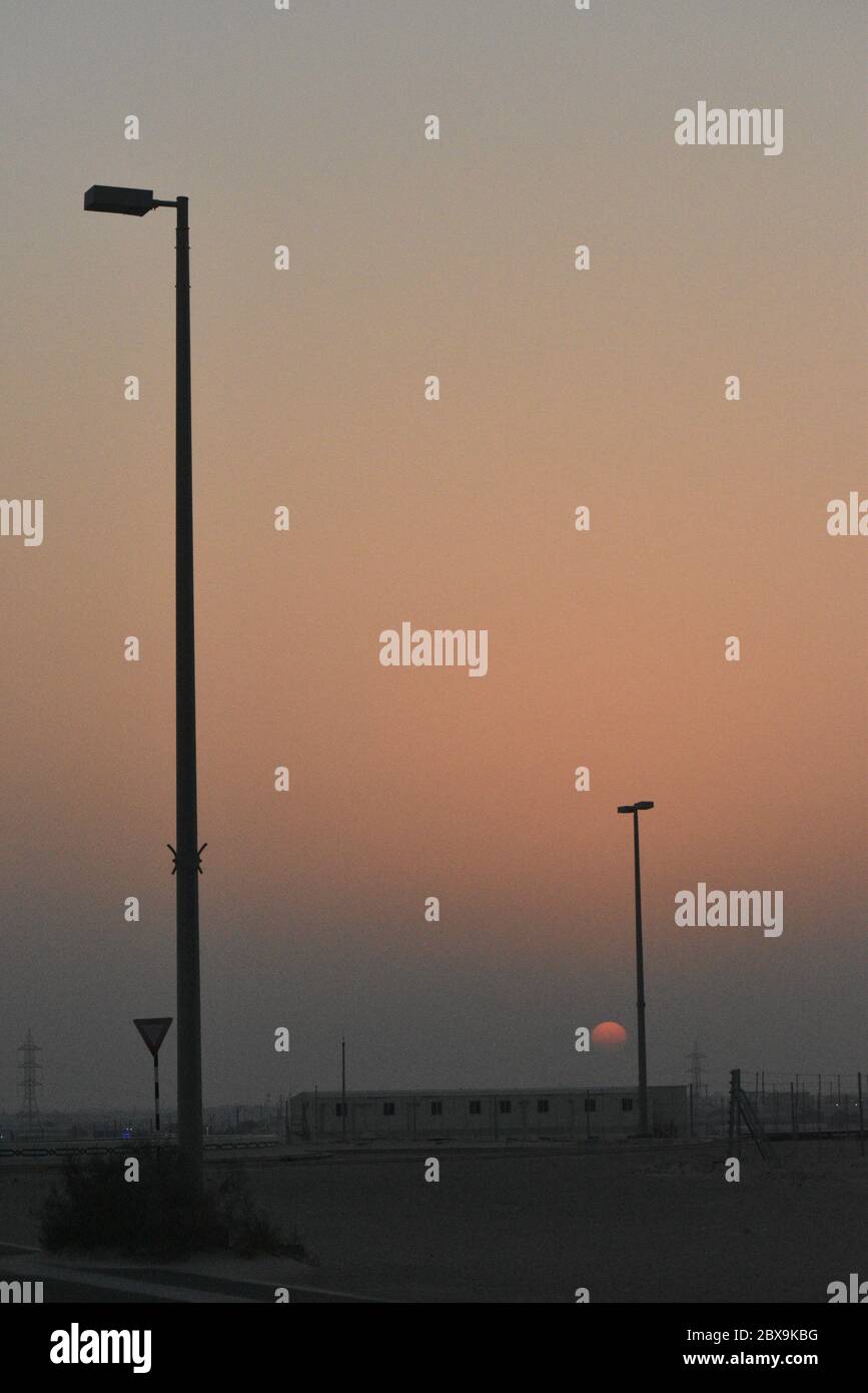 Sun in behind of two street lights Stock Photo - Alamy