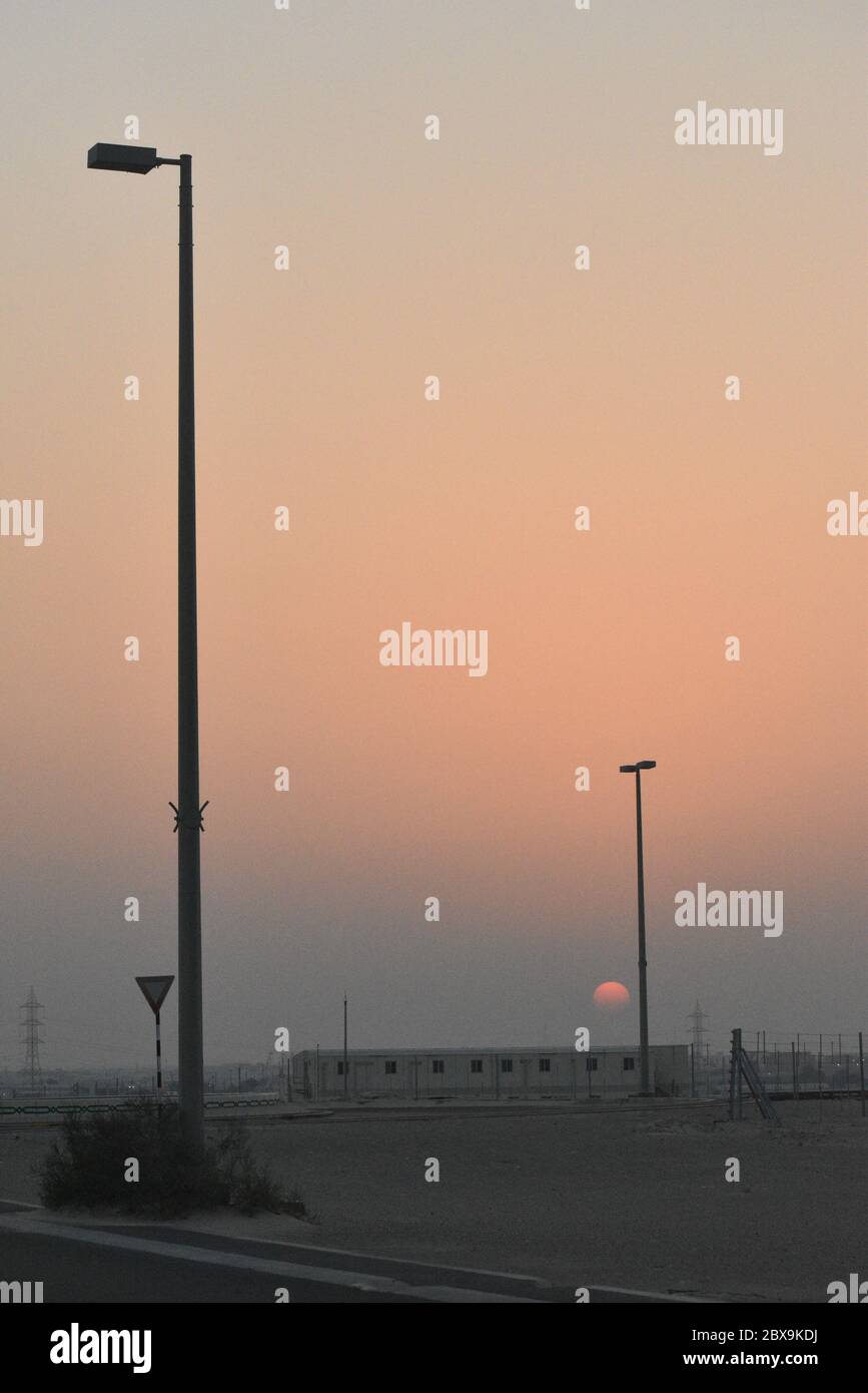 Sun in behind of two street lights Stock Photo - Alamy