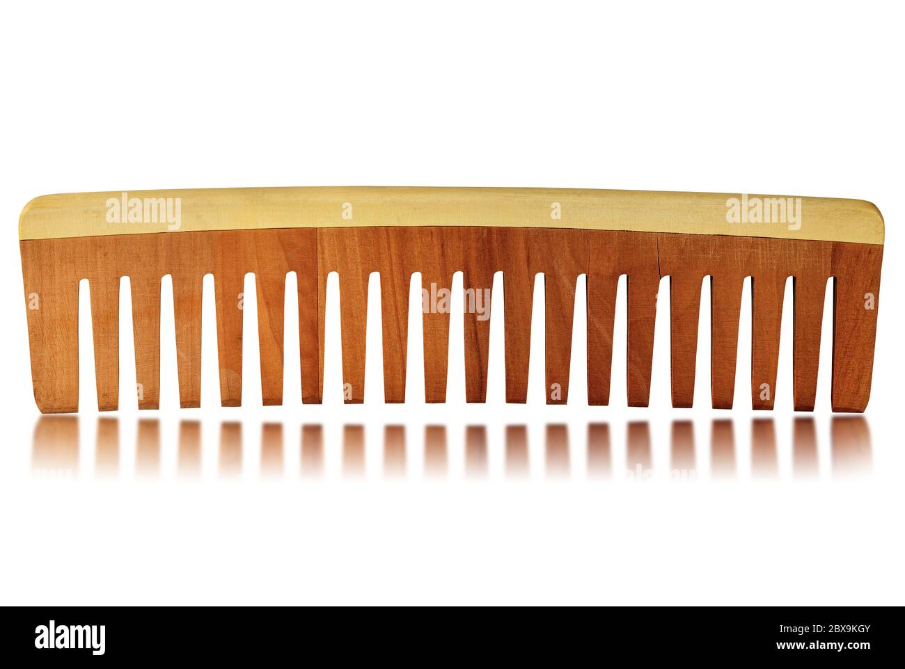 Close-up of a wooden comb for hair care isolated on a white background ...