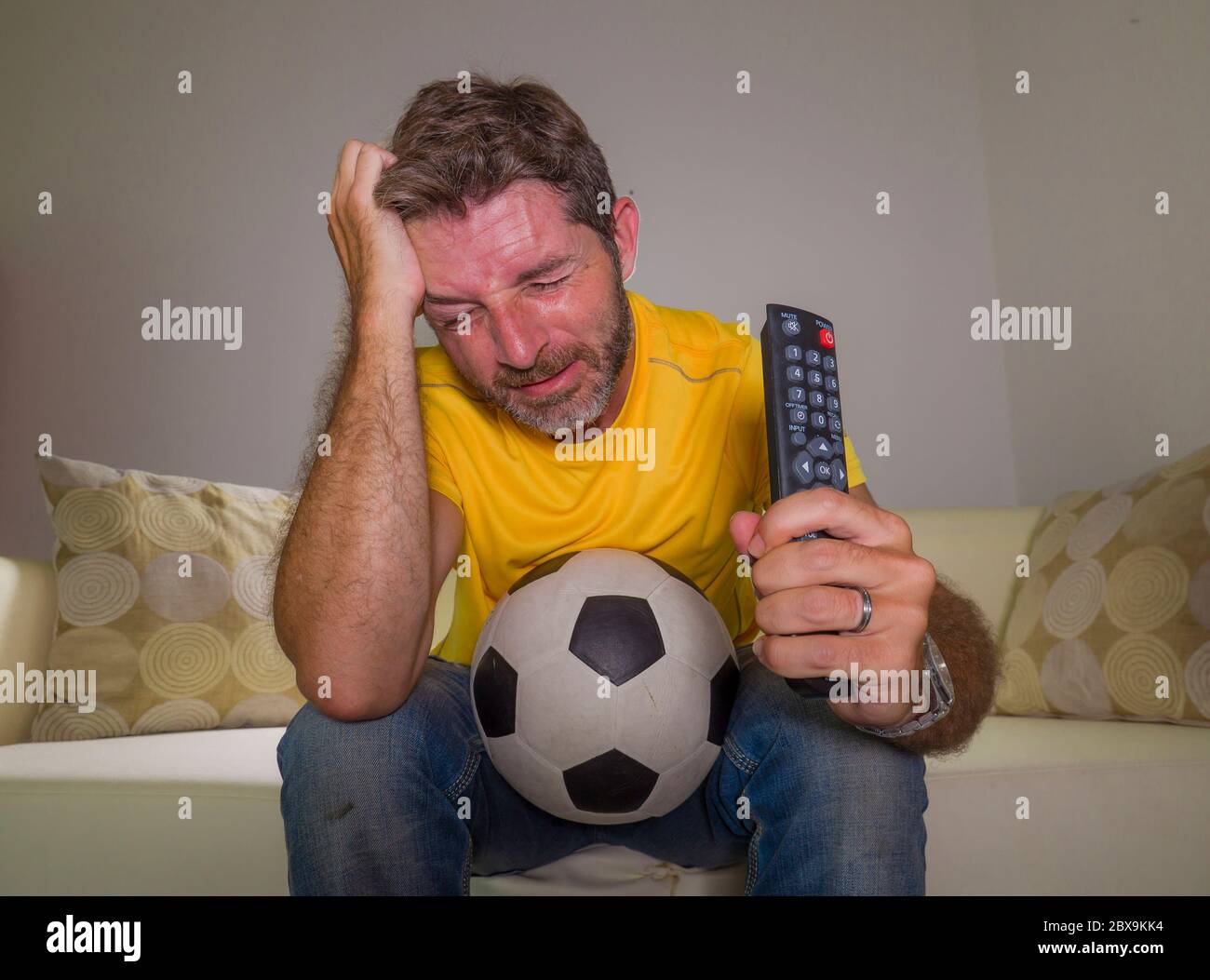 frustrated football fan in intense emotion - home portrait of young ...