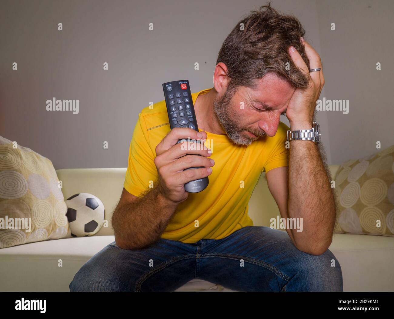 frustrated football fan in intense emotion - home portrait of young ...