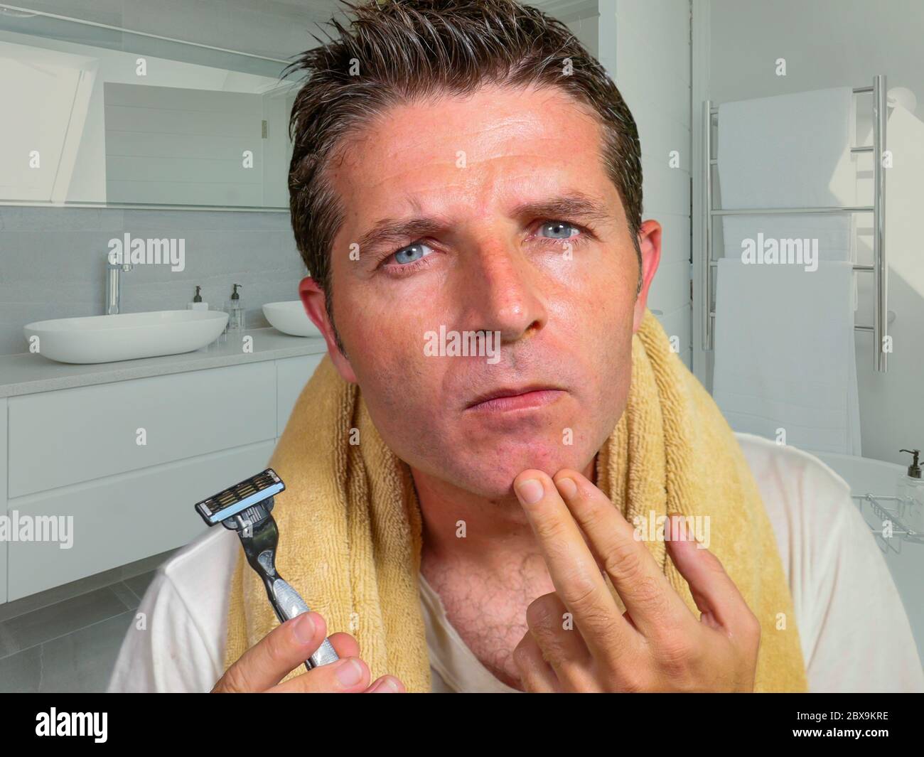 lifestyle home portrait of attractive and concentrated man holding ...