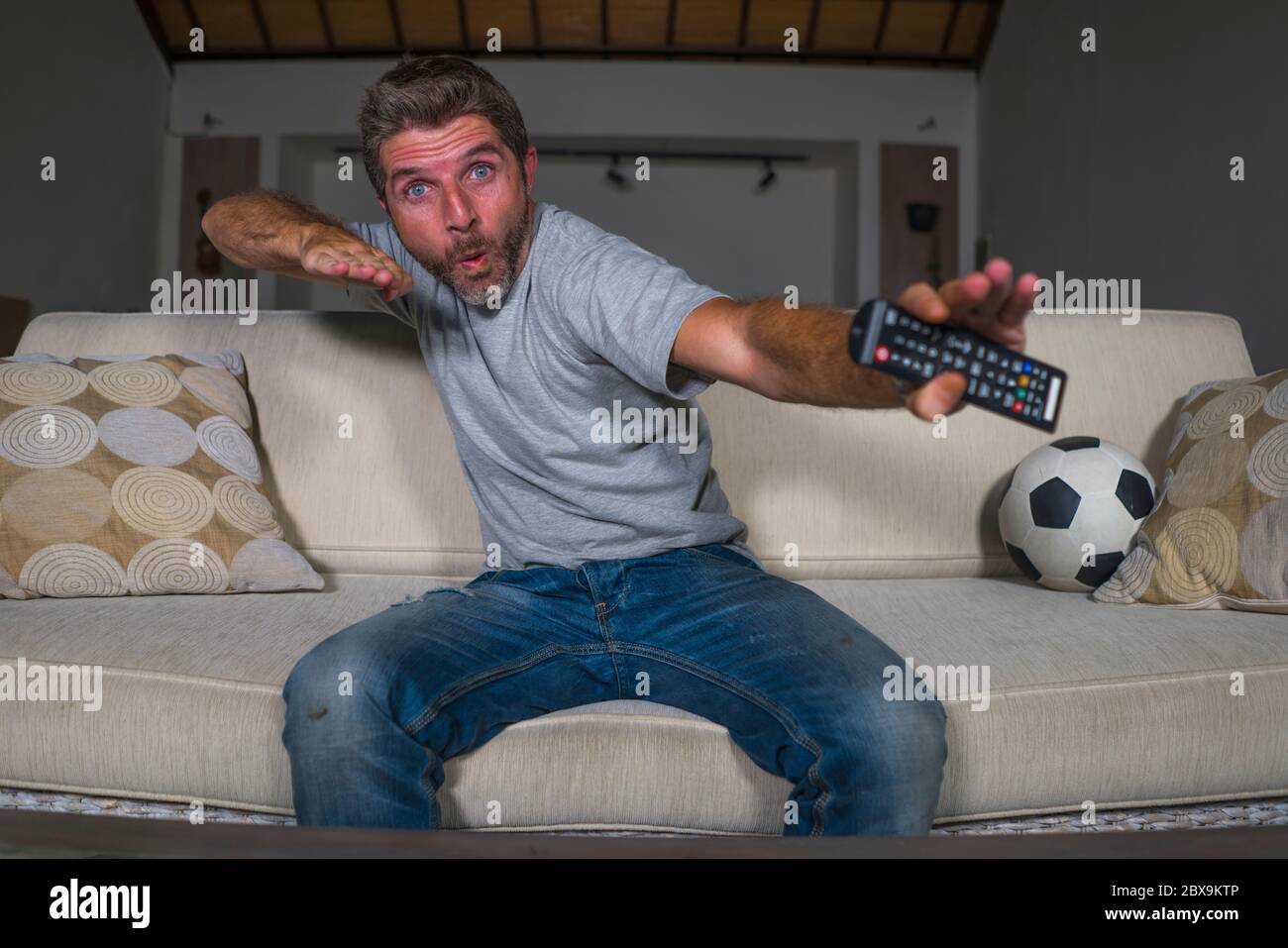 30s or 40s football fan man watching soccer game celebrating his team ...