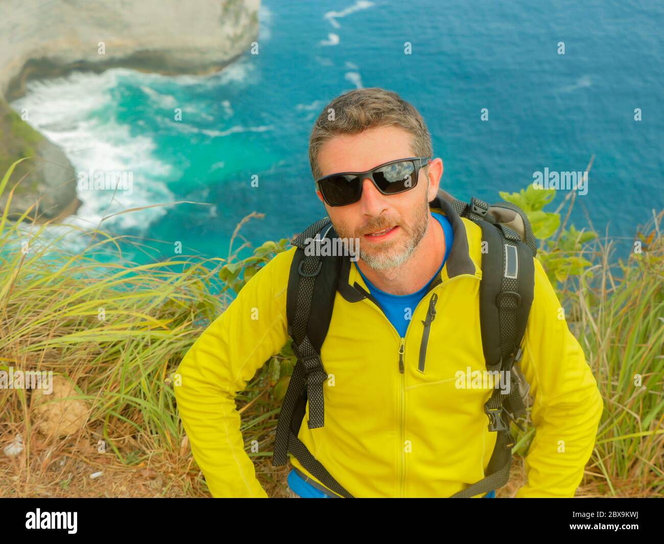 young happy and attractive sporty hiker man with trekking backpack ...