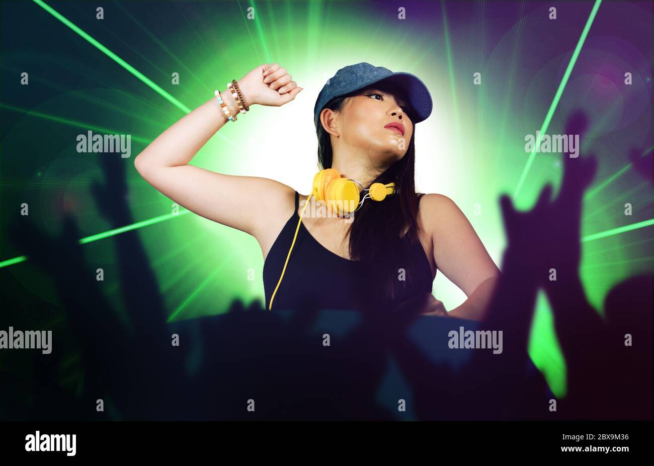 young attractive and cool Asian Chinese DJ woman with headphones at ...