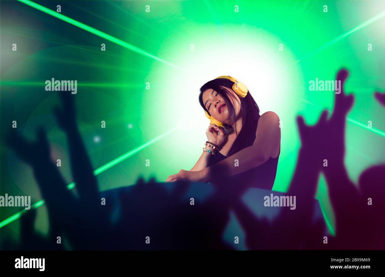 young attractive and cool Asian Chinese DJ woman with headphones at ...