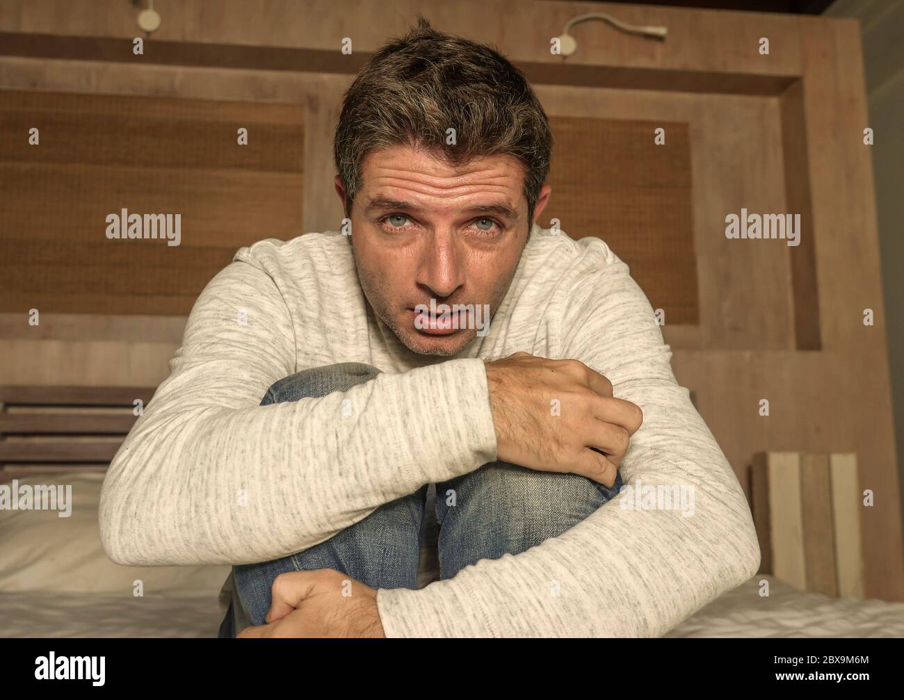 dramatic portrait of 30s or 40s scared and overwhelmed man suffering ...