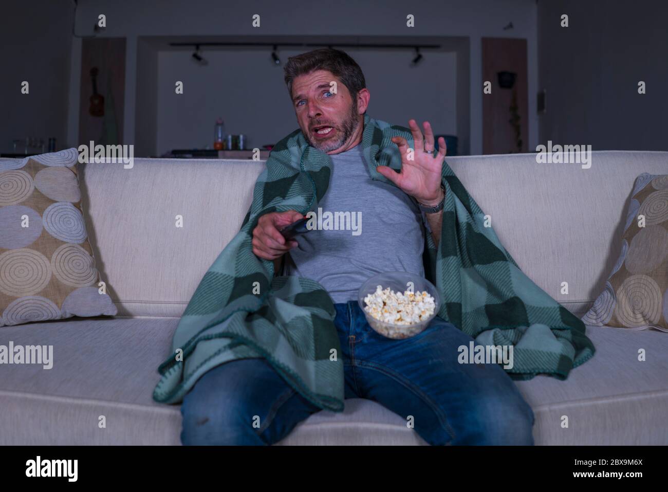 funny home lifestyle portrait of scared and frightened man alone at ...