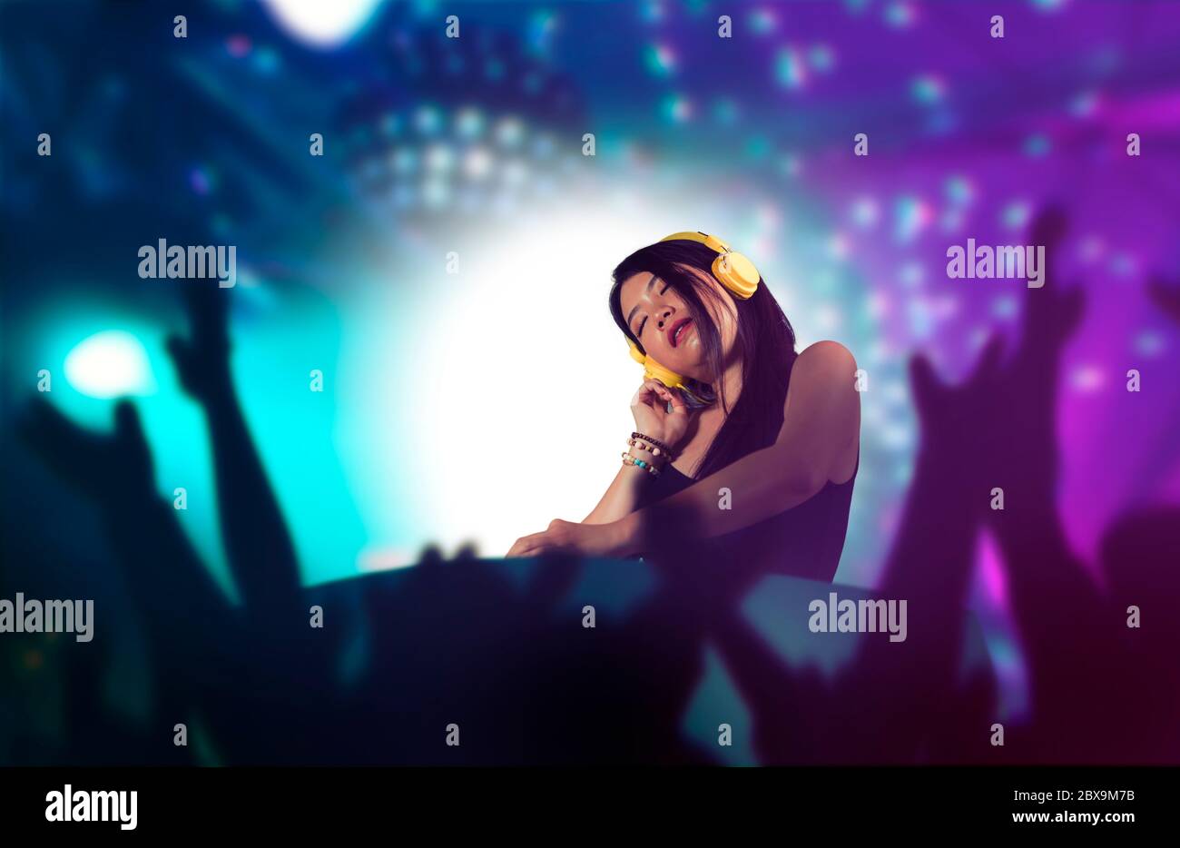 young attractive and cool Asian Japanese DJ woman with headphones at ...