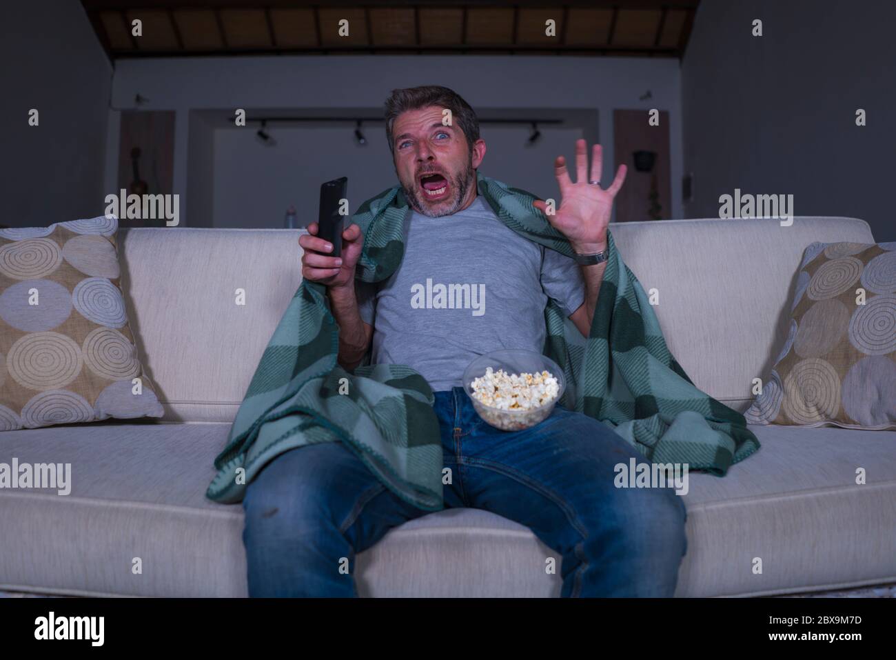 funny home lifestyle portrait of scared and frightened man alone at ...