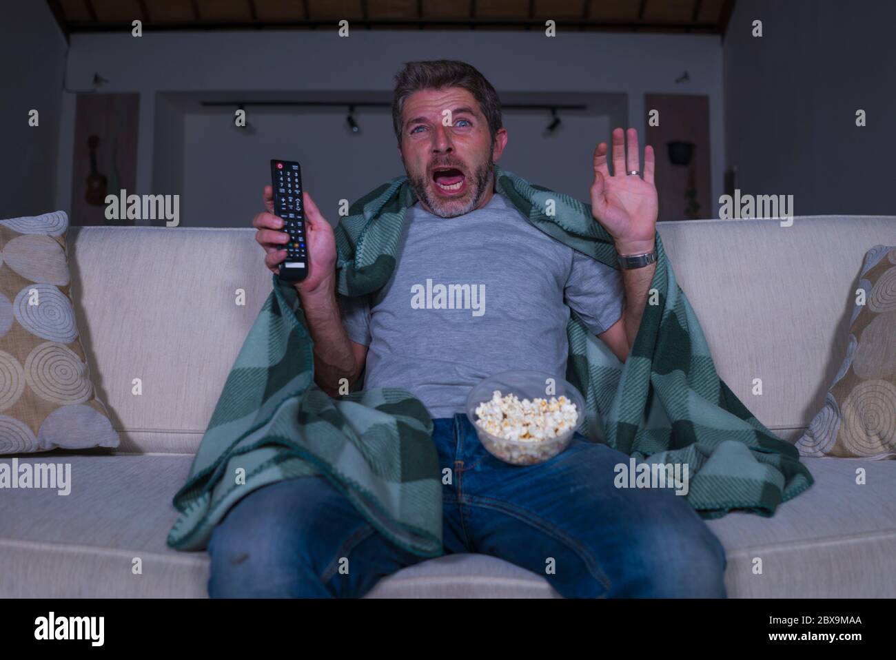 funny home lifestyle portrait of scared and frightened man alone at ...