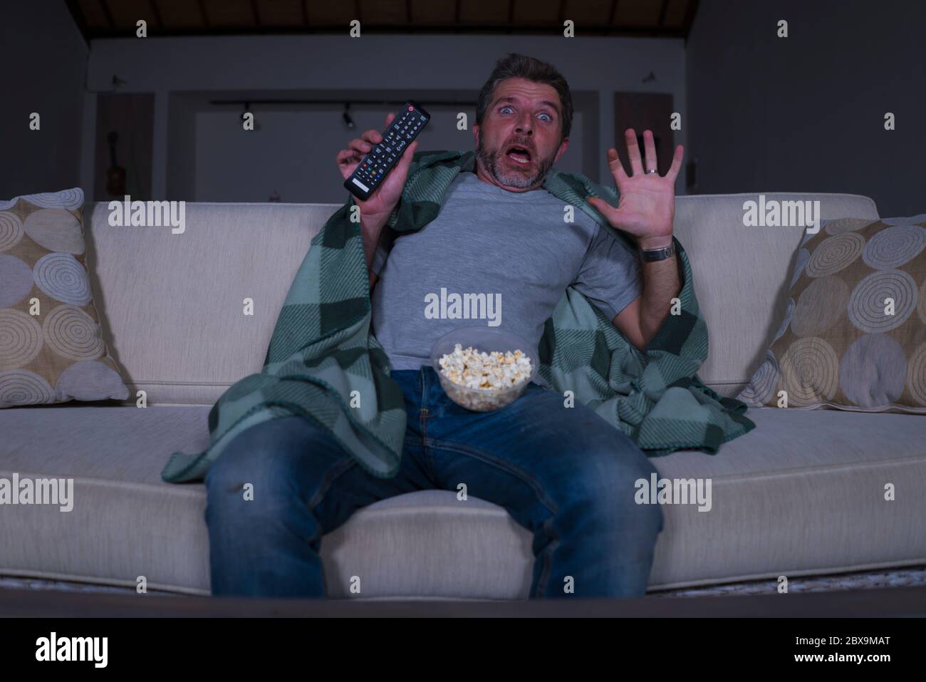 funny home lifestyle portrait of scared and frightened man alone at ...