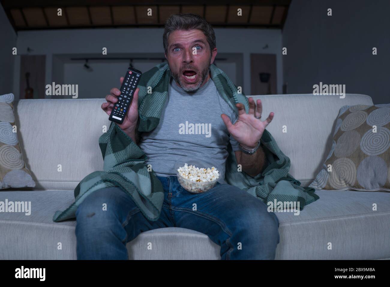 funny home lifestyle portrait of scared and frightened man alone at ...