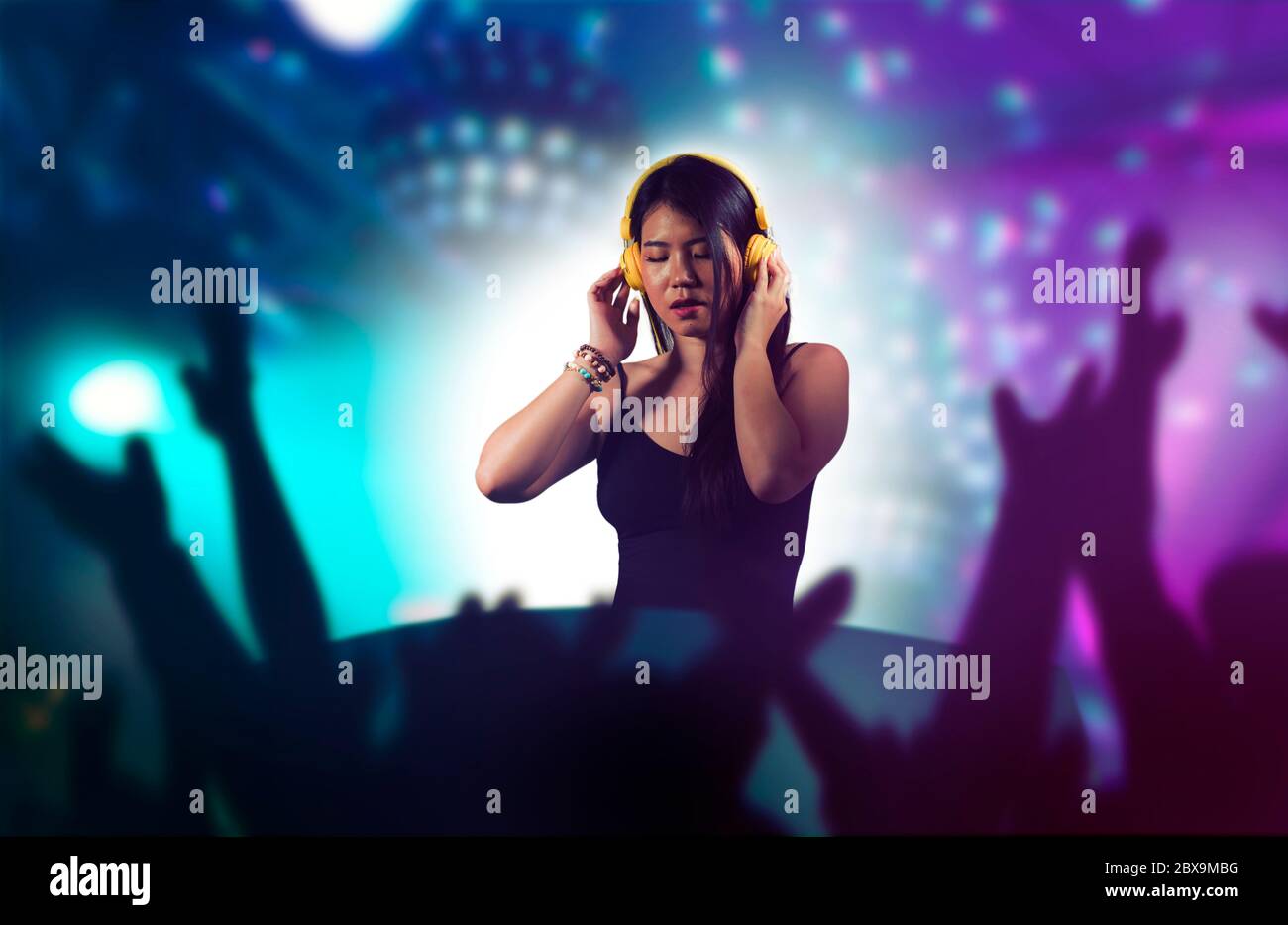 young attractive and cool Asian Korean DJ woman with headphones at ...