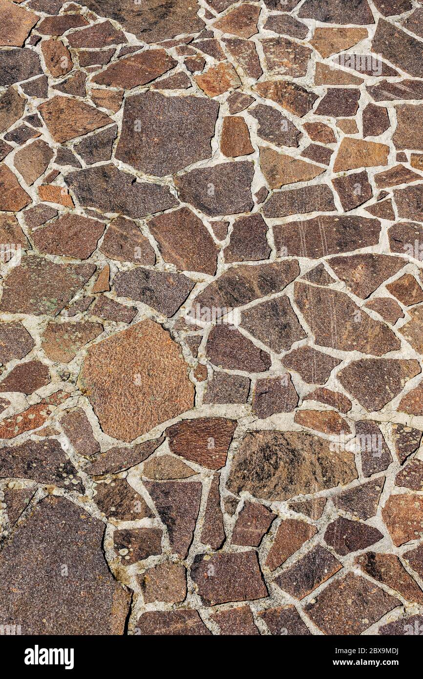 Close-up of an outdoor flooring made with irregular porphyry slabs ...