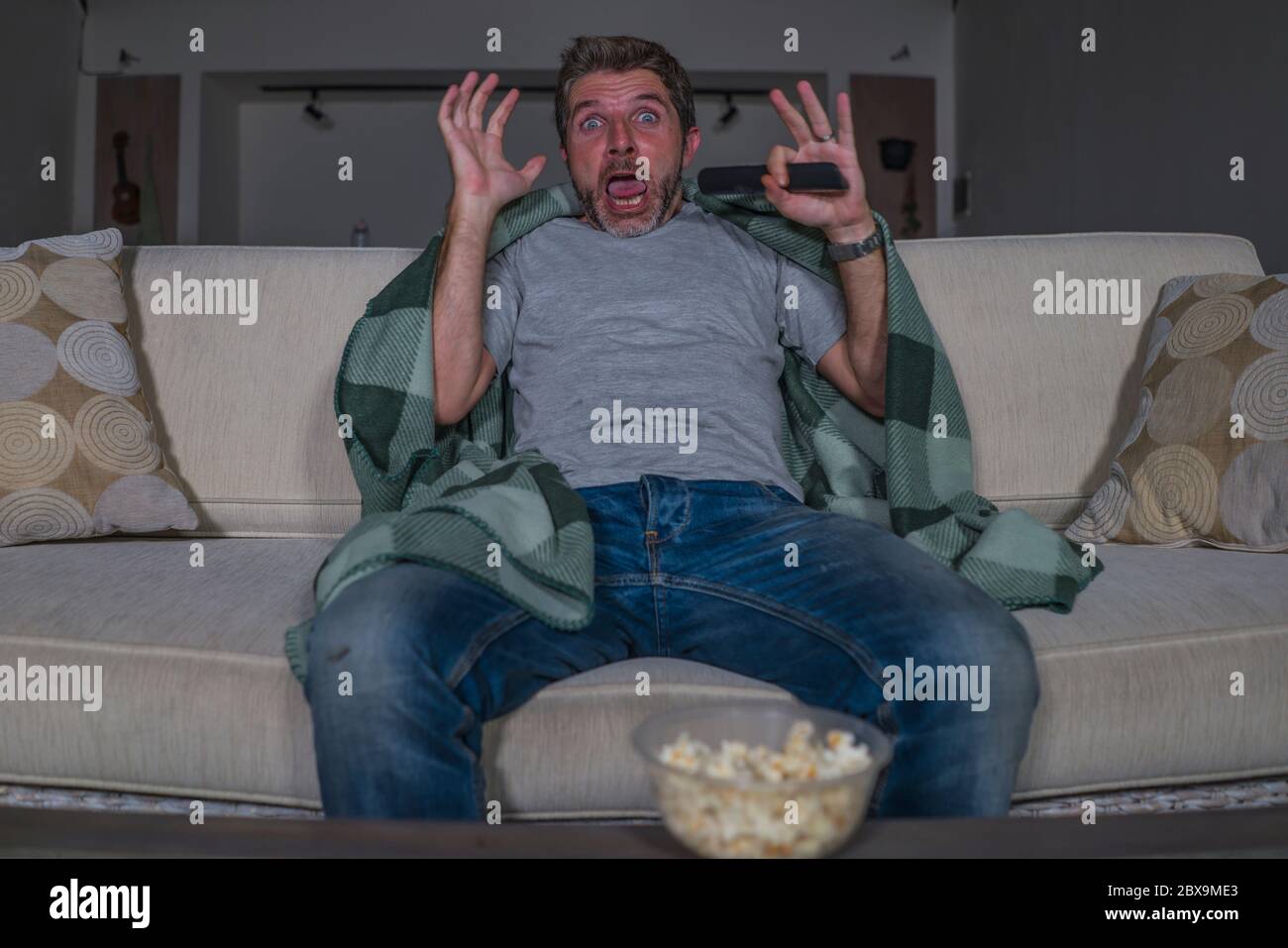 funny home lifestyle portrait of scared and frightened man alone at ...