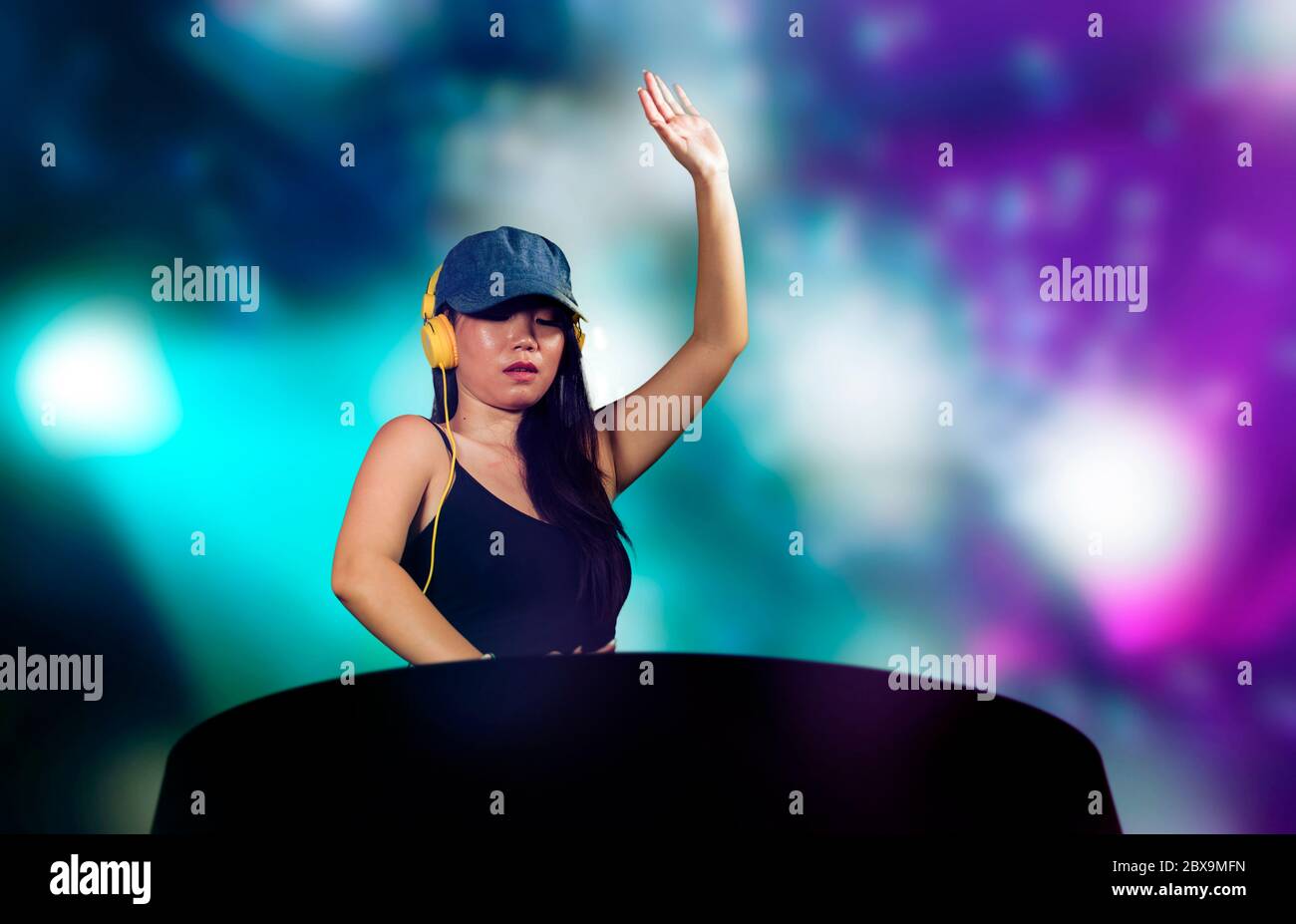 young attractive and cool Asian Korean DJ woman with headphones at ...