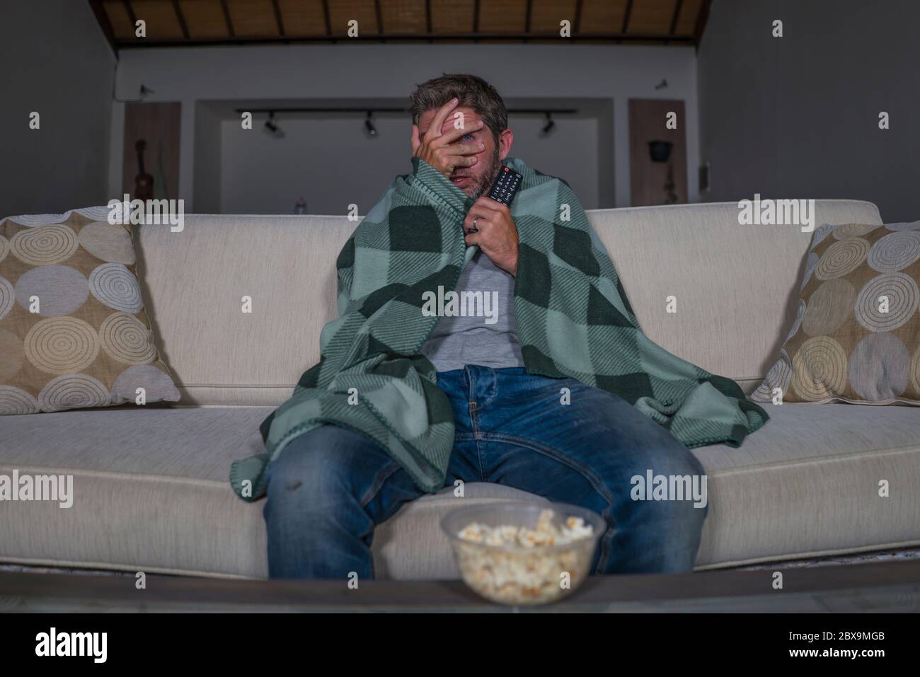 funny home lifestyle portrait of scared and frightened man alone at ...