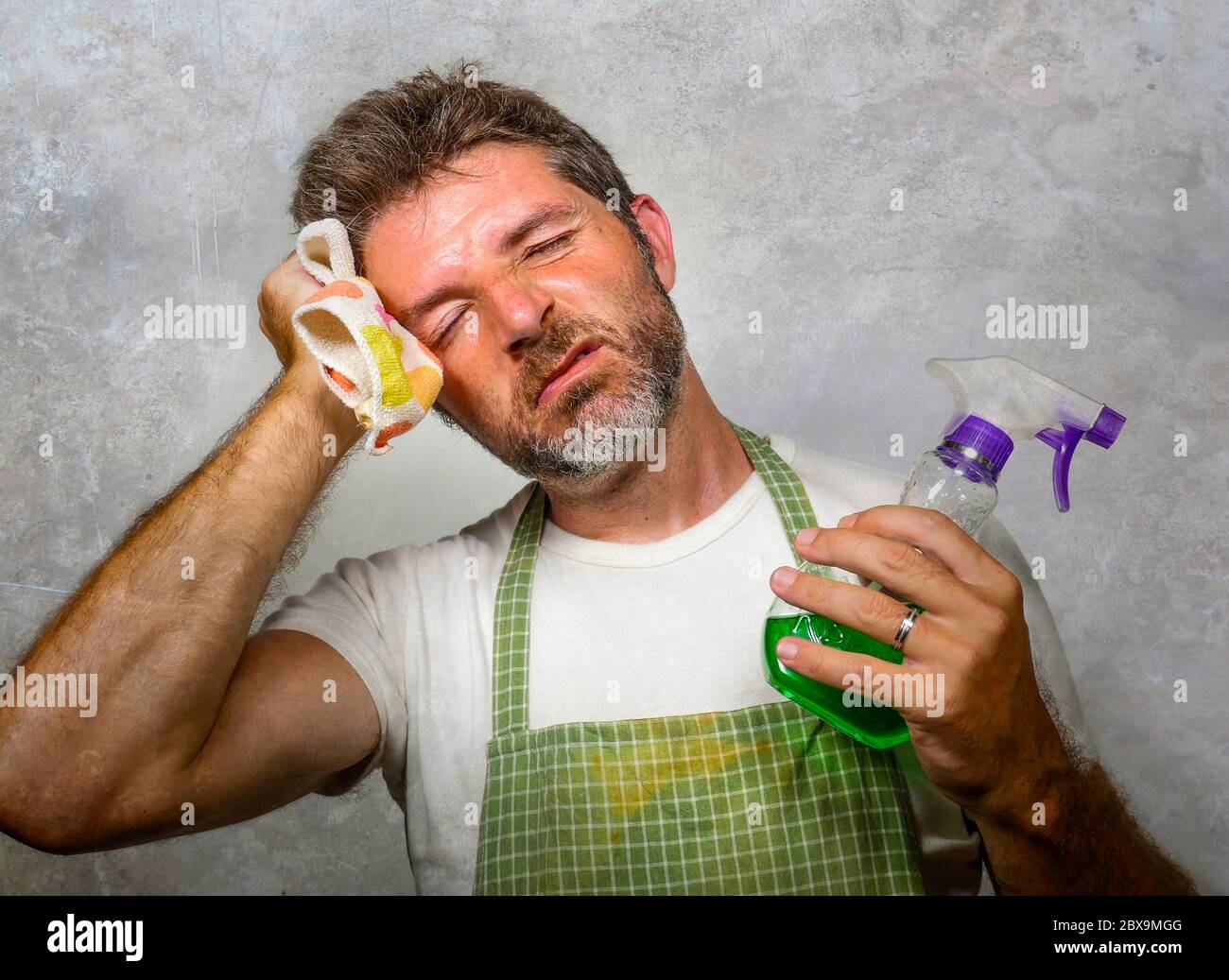 isolated portrait of 30s man in apron holding kitchen cloth and ...
