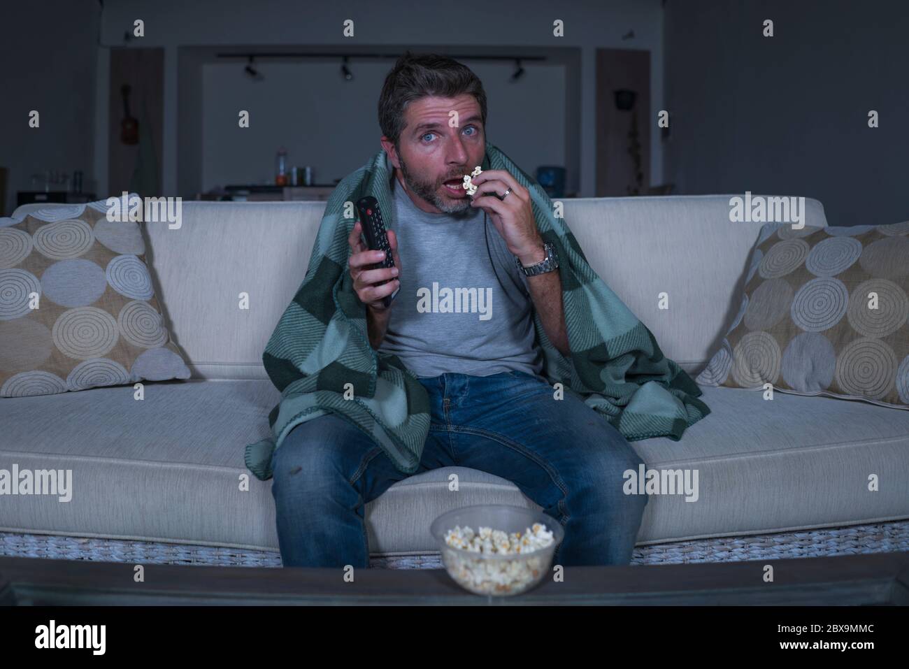funny home lifestyle portrait of scared and frightened man alone at ...