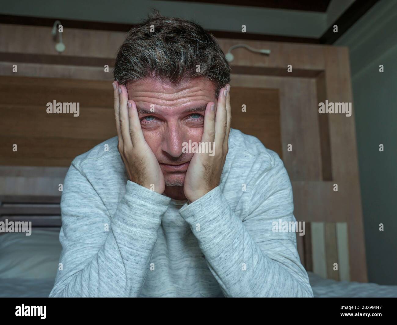 dramatic home portrait of 30s to 40s attractive depressed and desperate ...