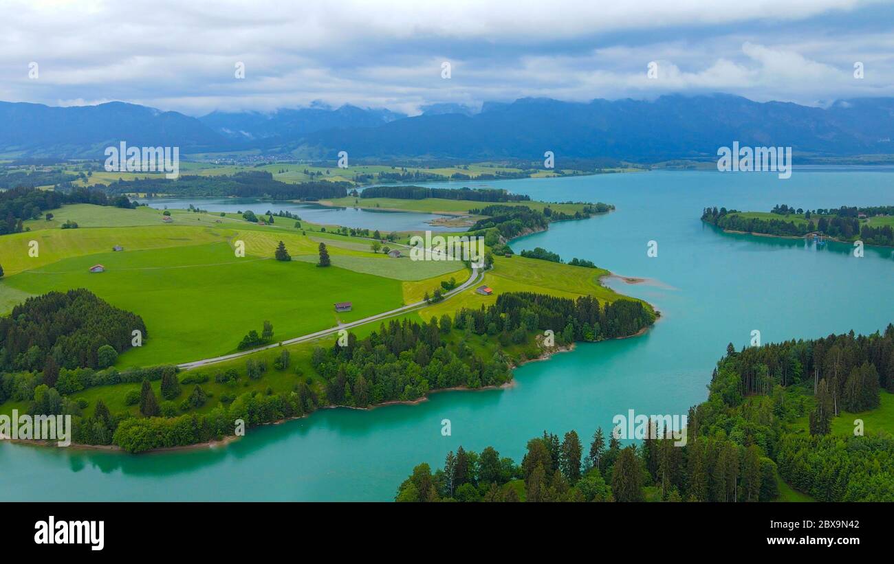Aerial view over Lake Forggensee at the city of Fuessen in Germany ...