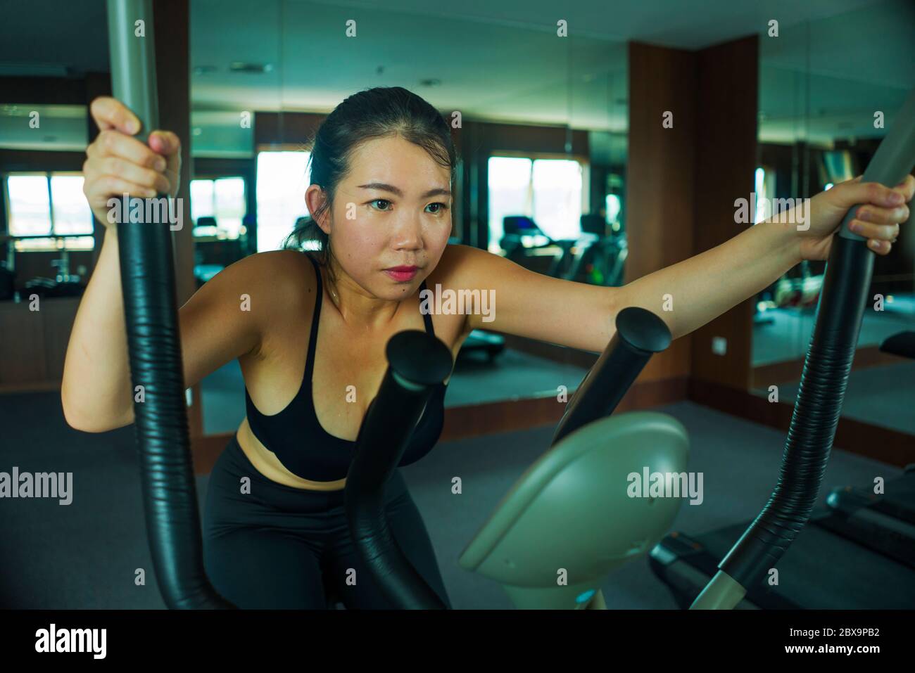 young beautiful and attractive Asian Korean woman training at hotel gym ...