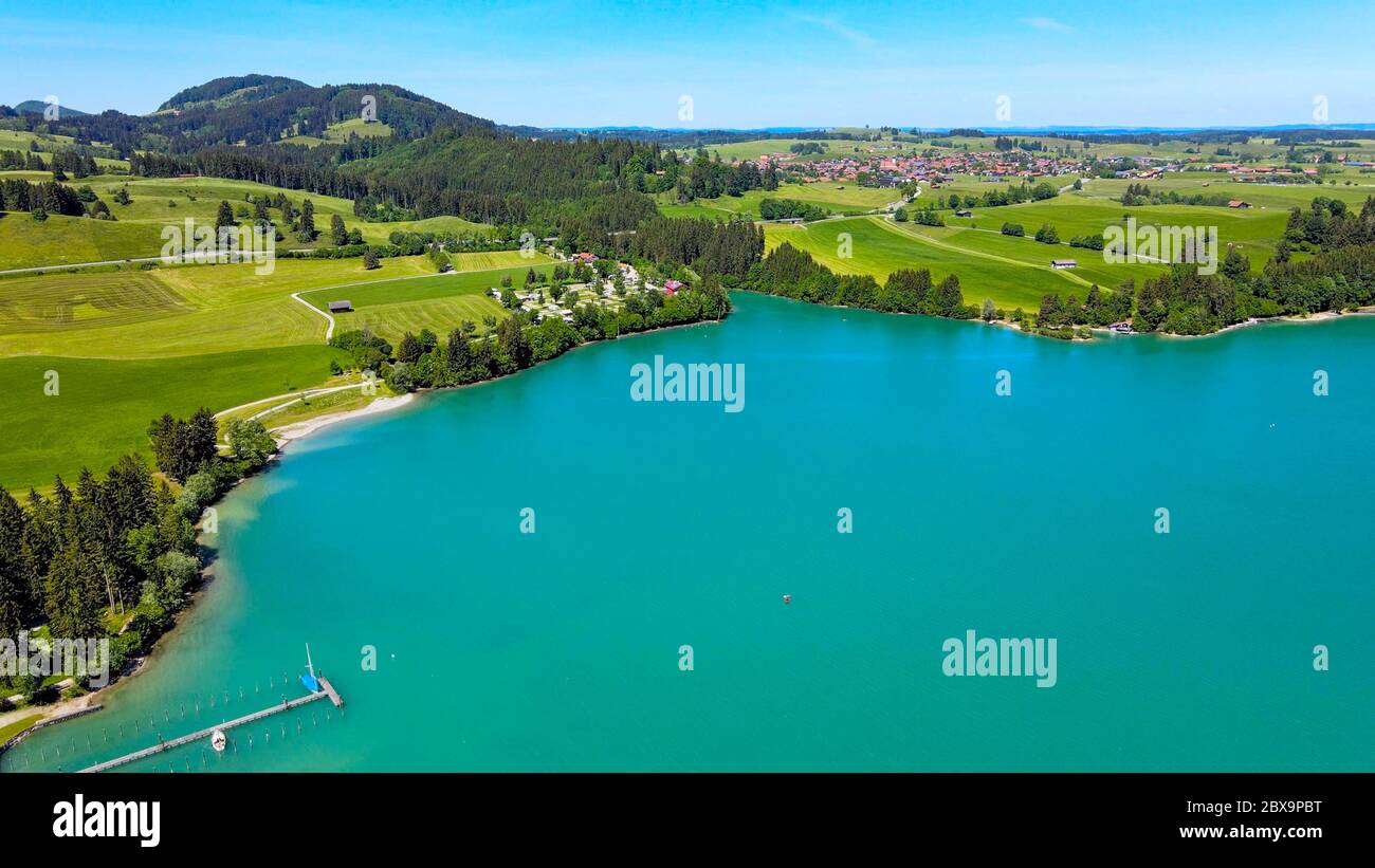 Aerial view over Lake Forggensee at the city of Fuessen in Germany ...
