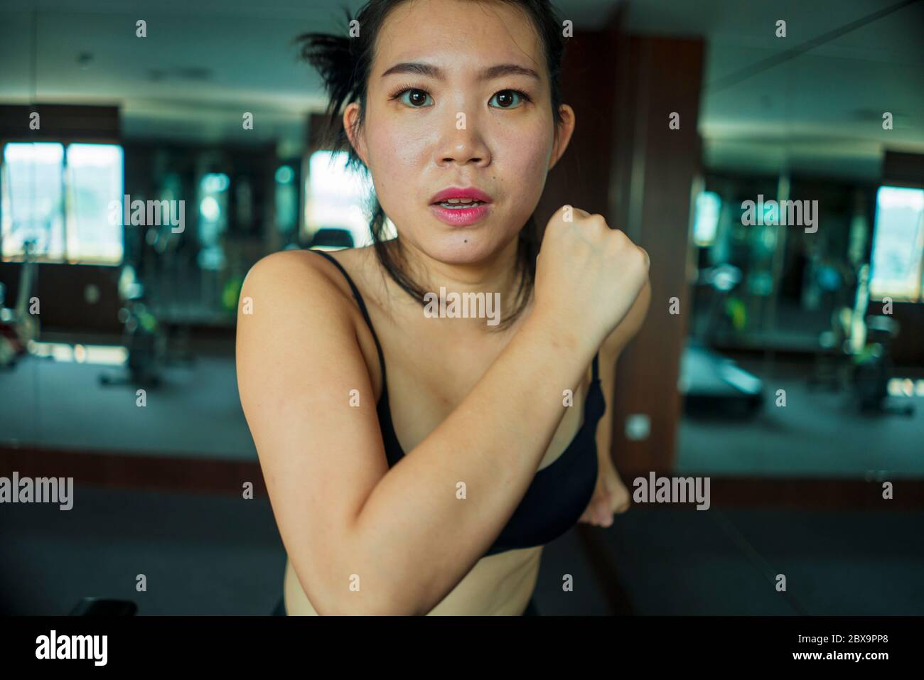 young attractive and fit Asian Korean woman doing running workout at ...