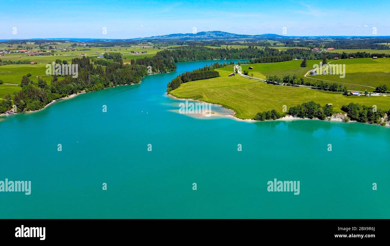 Aerial view over Lake Forggensee at the city of Fuessen in Germany ...