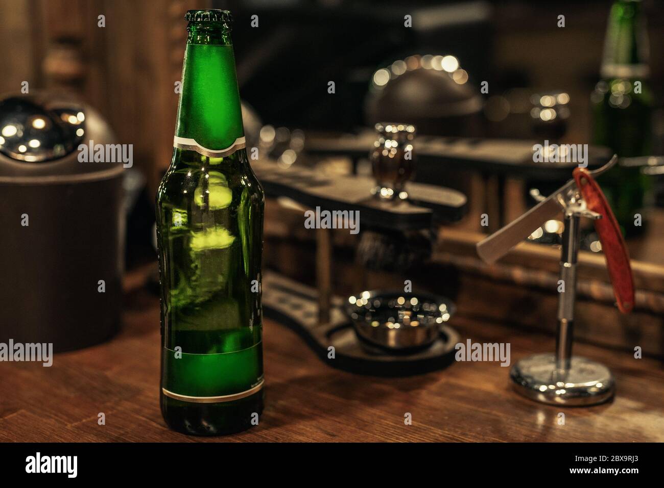 Bottle lager beer on a brown vintage barber table, near shaving and ...
