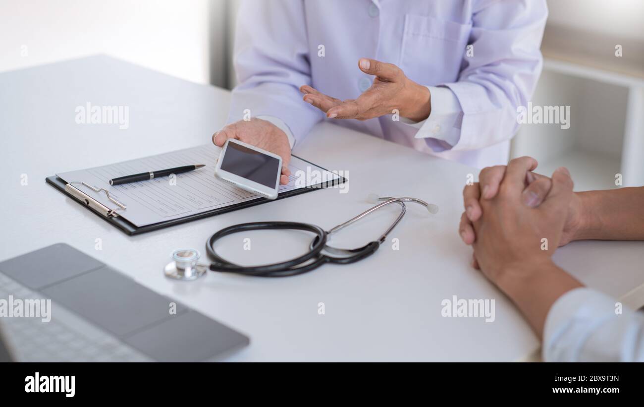 doctor giving consulting and diagnostic to patient and explaining ...