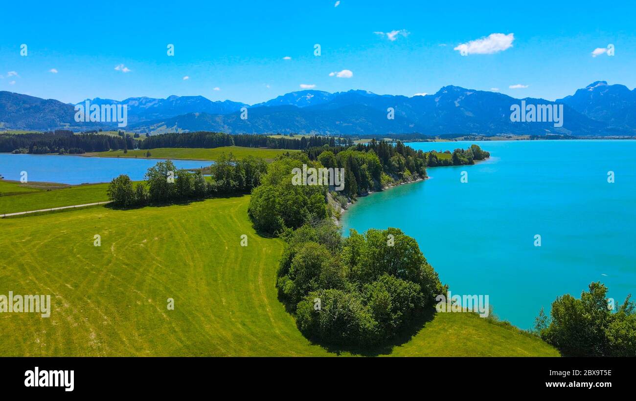 Aerial view over Lake Forggensee at the city of Fuessen in Germany ...