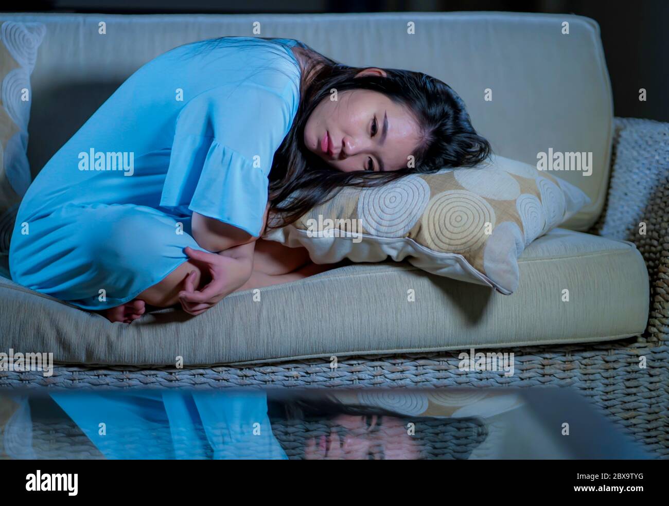 dramatic lifestyle portrait of young beautiful sad and depressed Asian ...