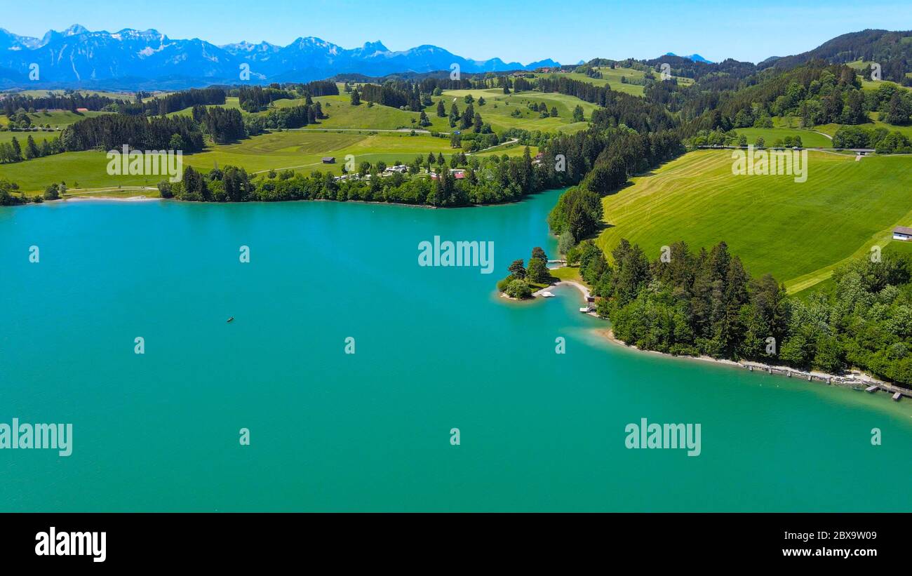 Aerial view over Lake Forggensee at the city of Fuessen in Germany ...