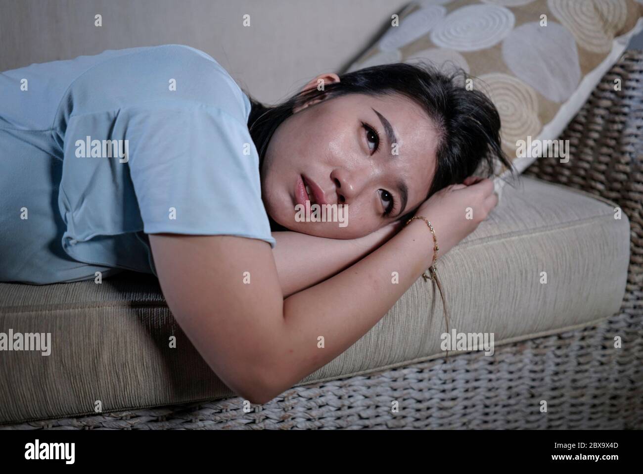 dramatic lifestyle portrait of young sad and depressed Asian Japanese ...