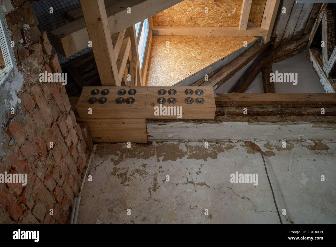 on an old building site, old ceiling beams are reinforced with new ...