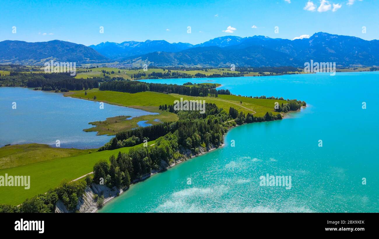 Aerial view over Lake Forggensee at the city of Fuessen in Germany ...